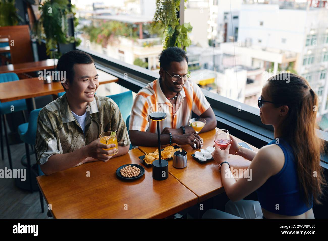 Diverse group friends celebrate talk hi-res stock photography and ...
