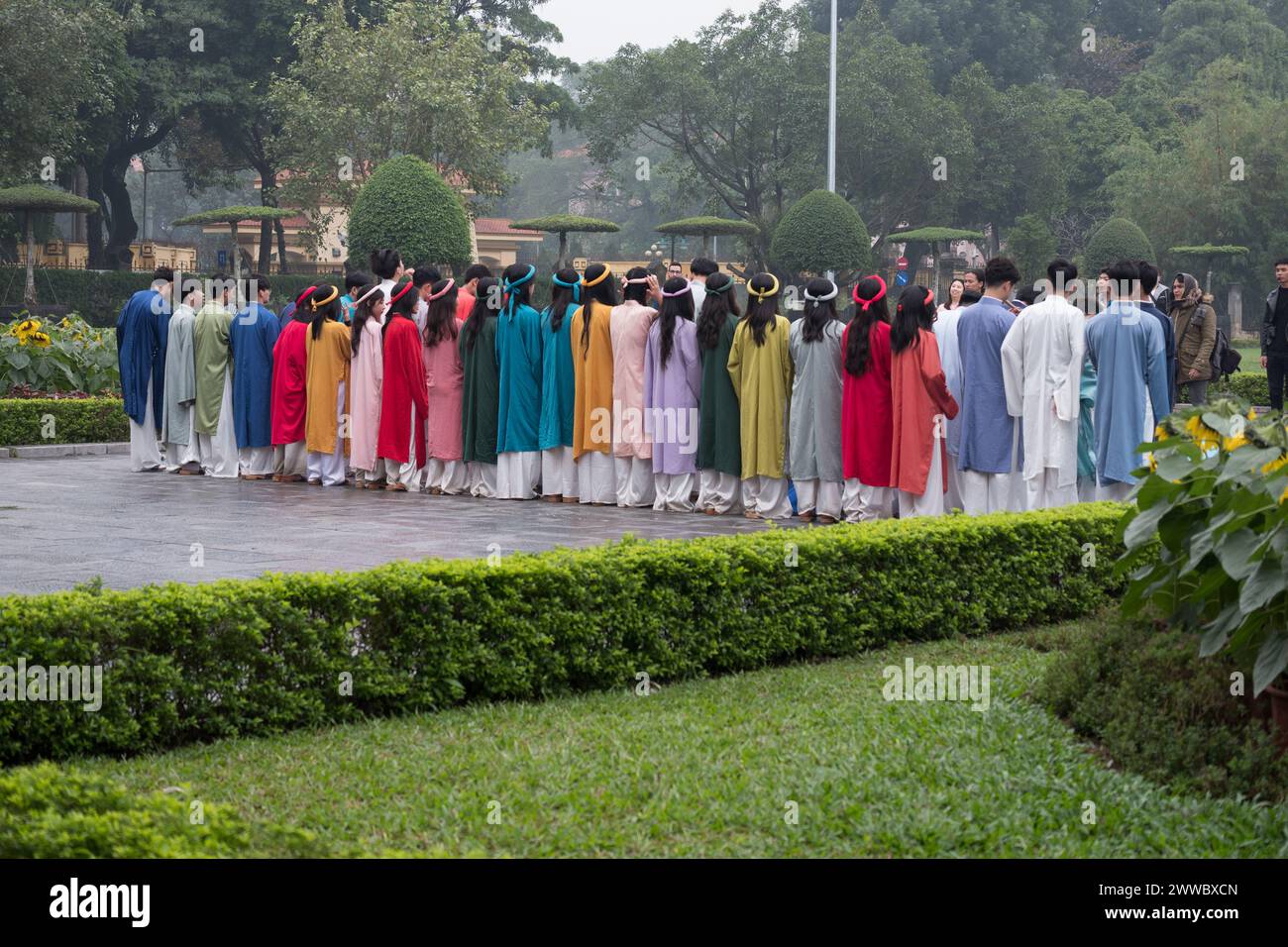 A lively group of students, dressed in colorful and traditional attire ...