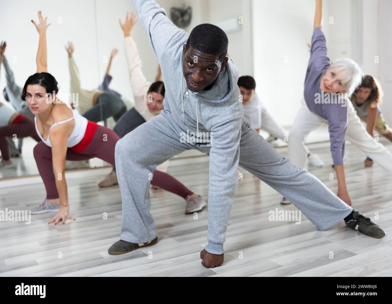 Happy african man learning new modern dance in group dance lesson Stock ...