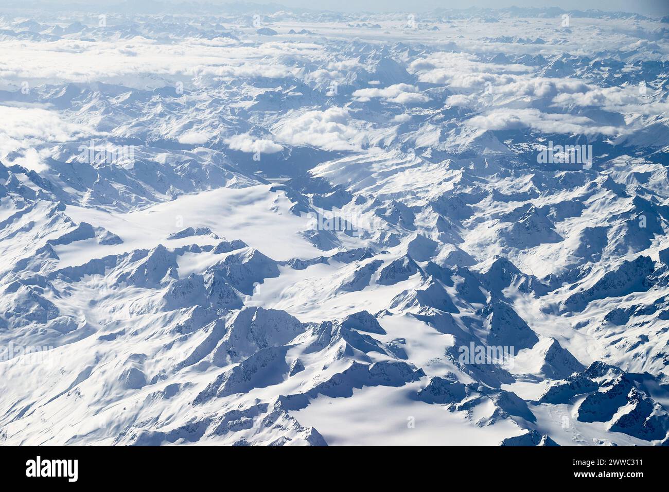 4 March 2024: Aerial view of the snow-covered mountains in the Alps ...