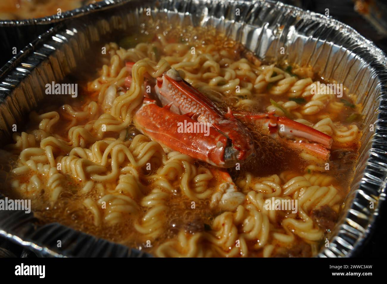 Instant ramen boiled in an aluminum disposable container with seafood ...