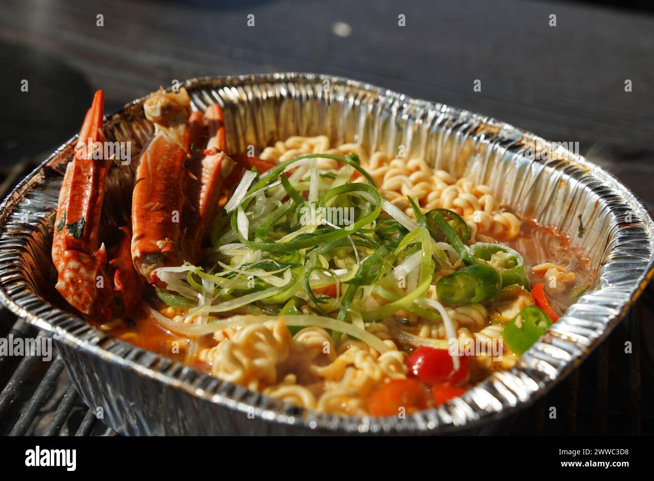 Instant ramen boiled in an aluminum disposable container with seafood ...