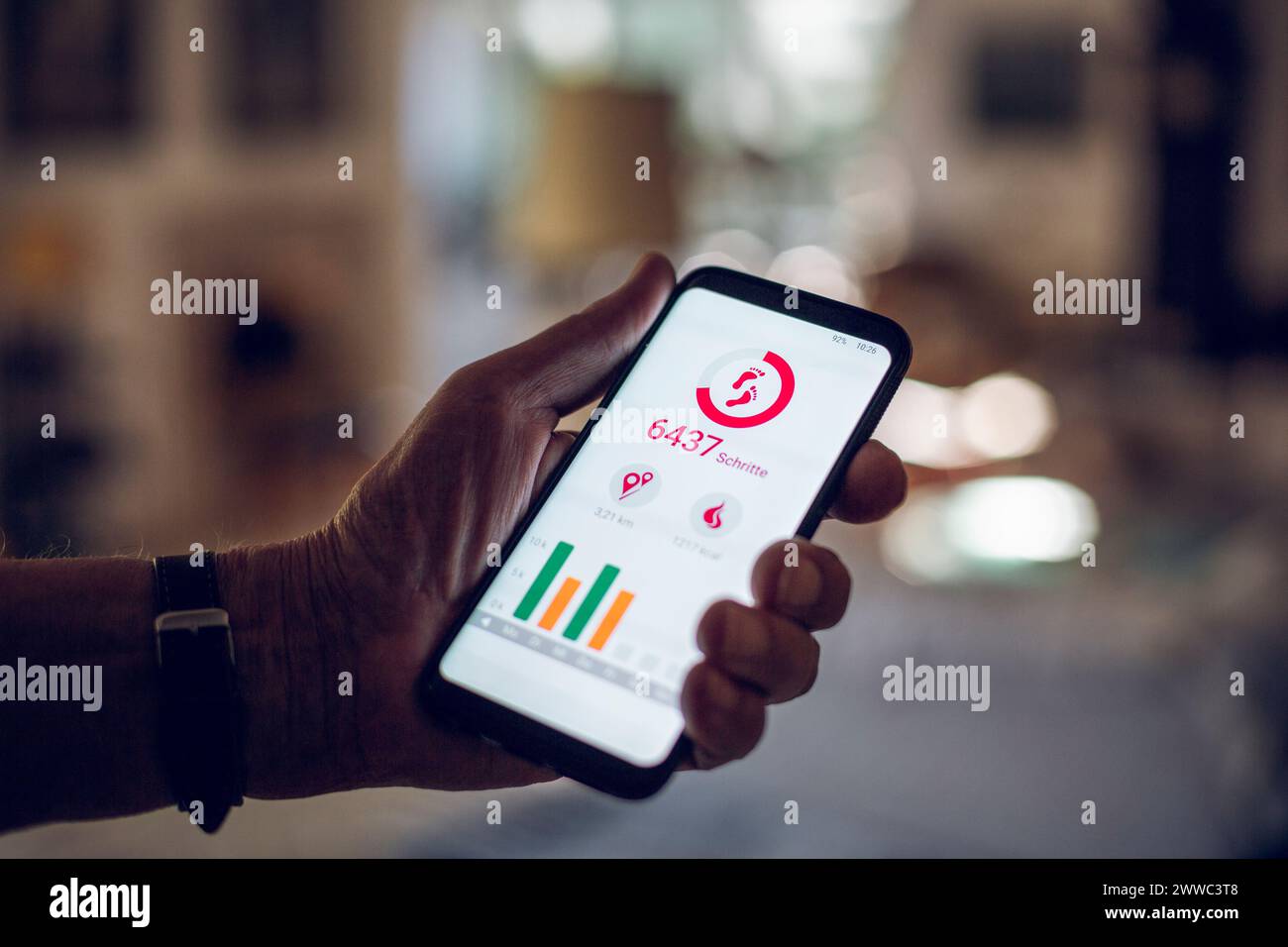 Senior holding smartphone, using fitness app Stock Photo - Alamy