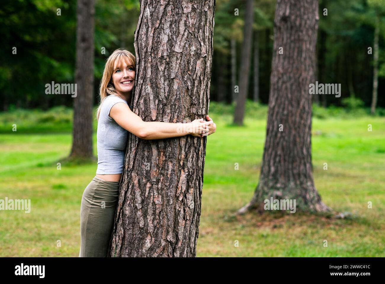 Tree hugging young woman arms hi-res stock photography and images - Alamy