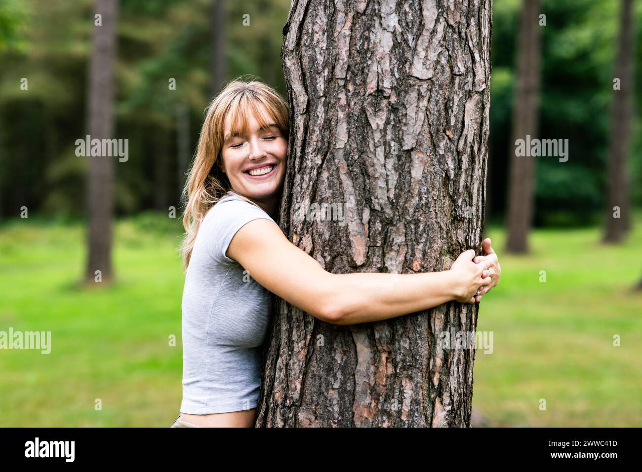 Tree hugging young woman arms hi-res stock photography and images - Alamy