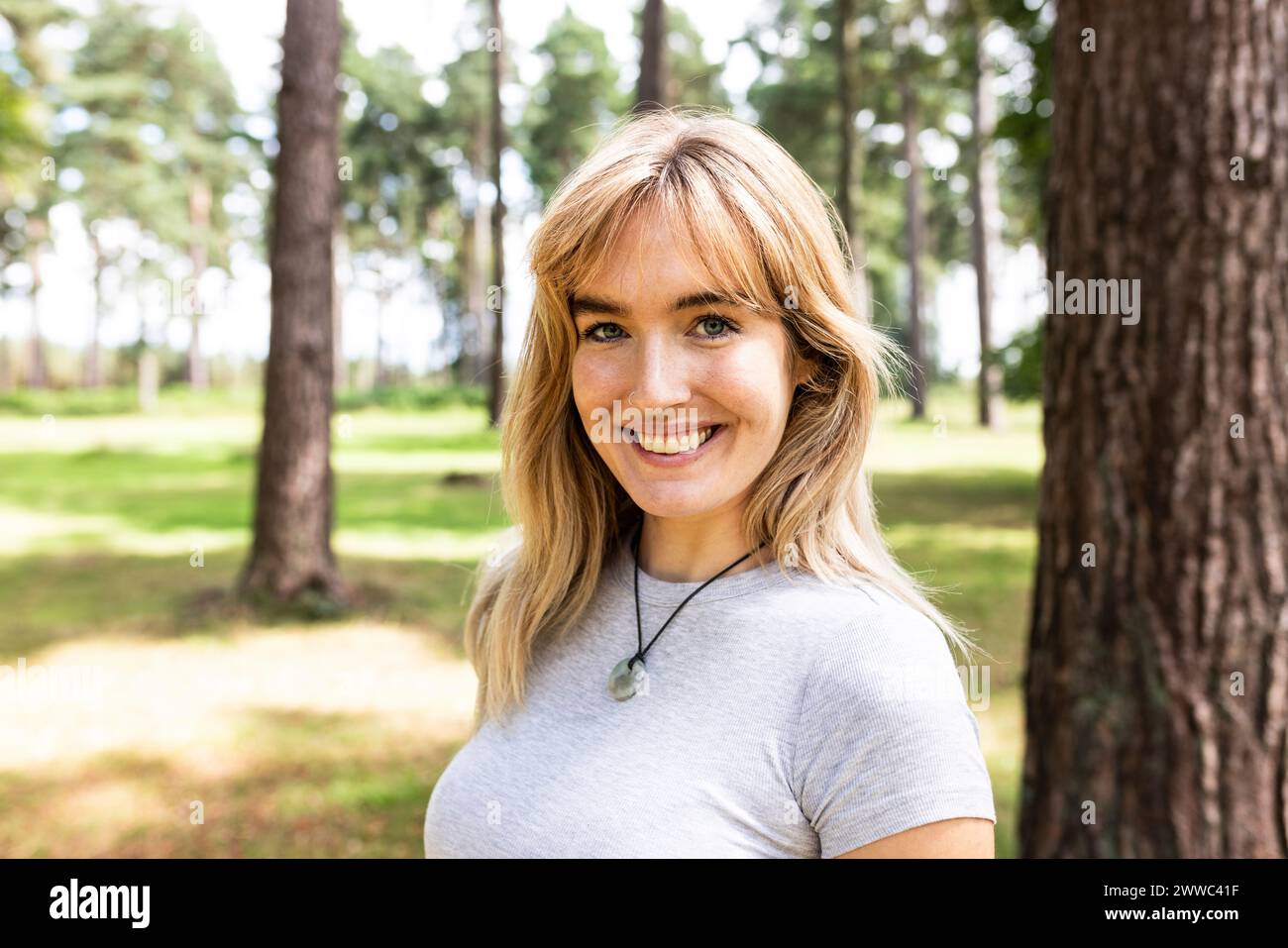 Woman stand near tree hi-res stock photography and images - Alamy