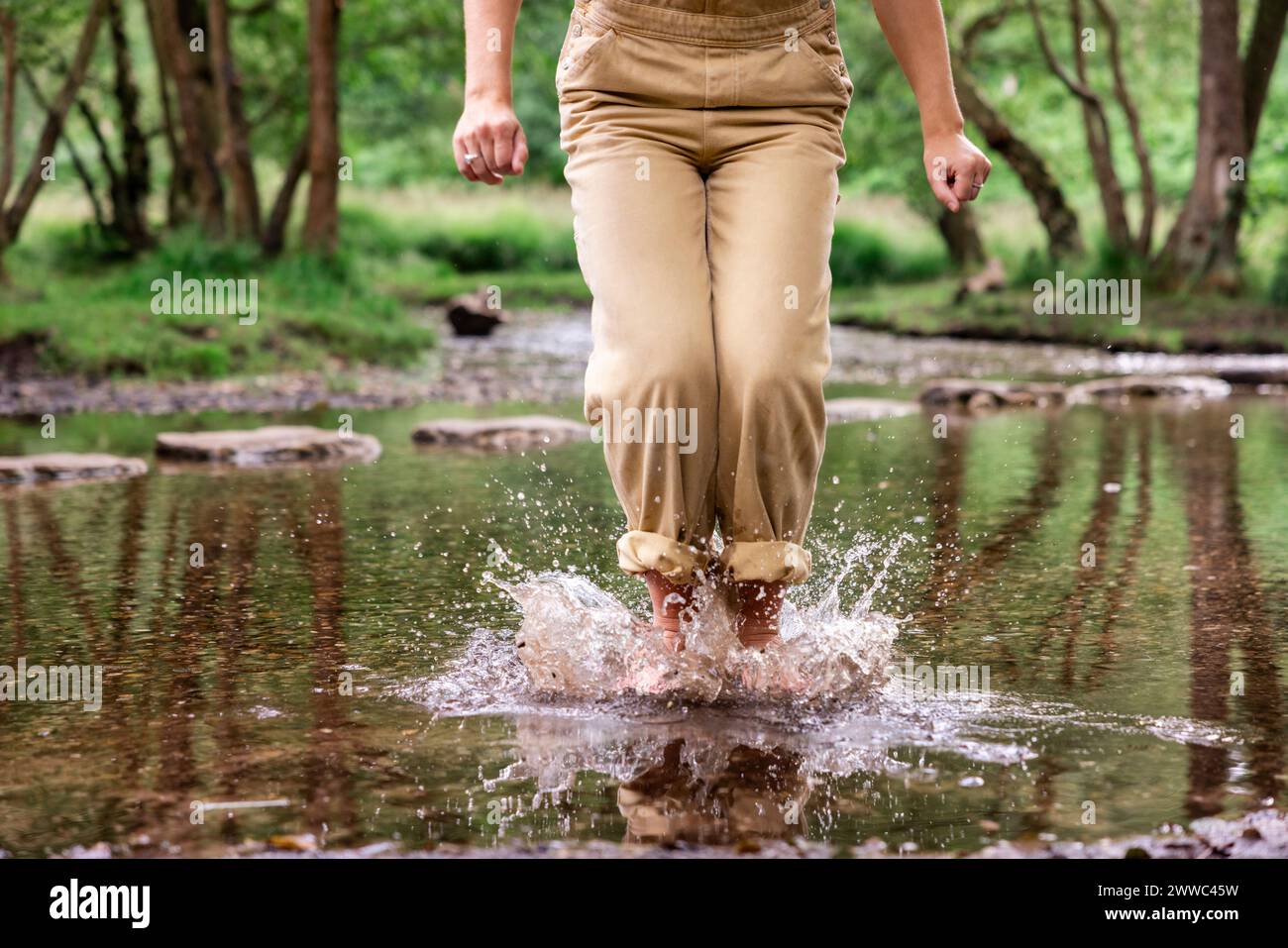 Woman jumping in river water Stock Photo - Alamy