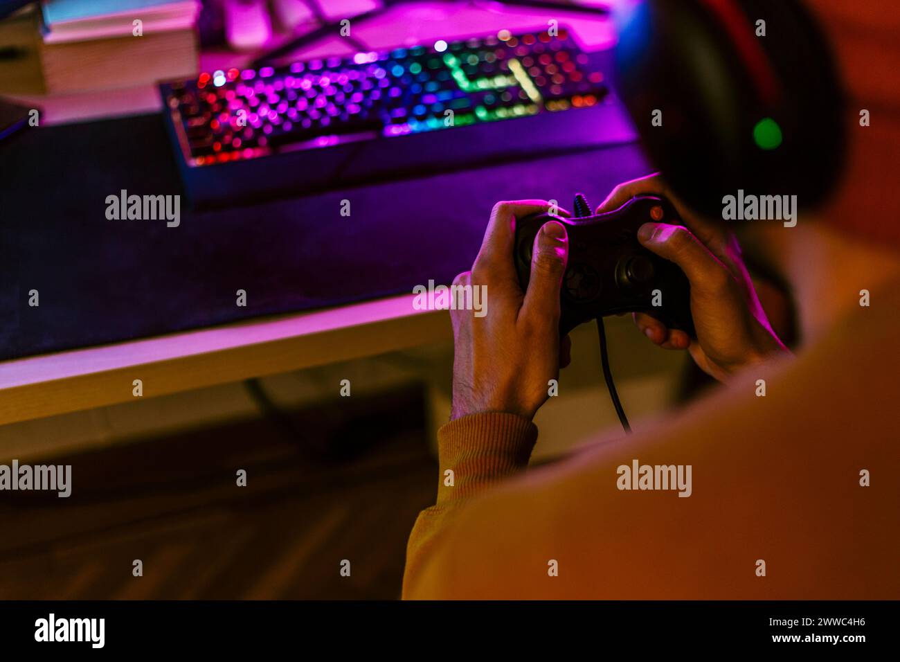 Gaming influencer playing video games using controller at home Stock ...