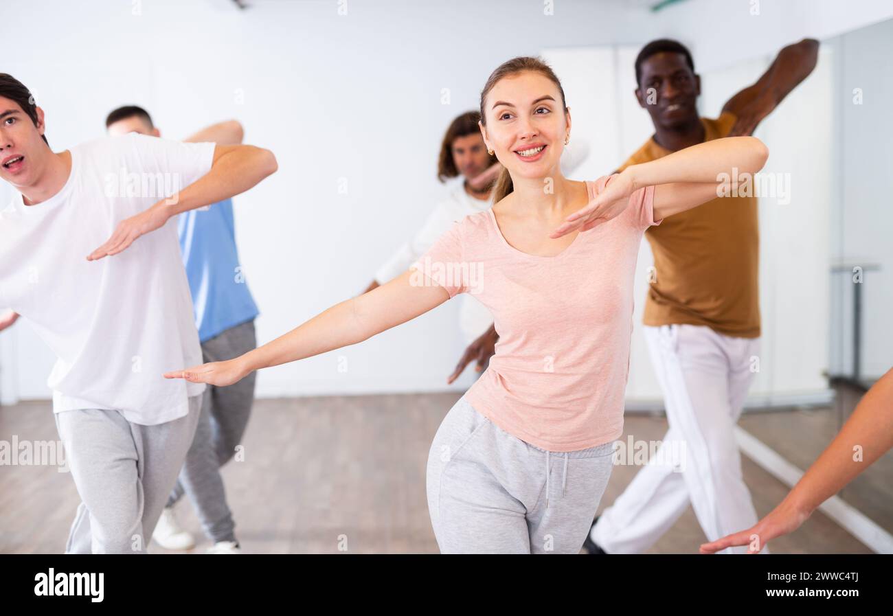 Group of different people rehearsing dance in dance studio Stock Photo ...