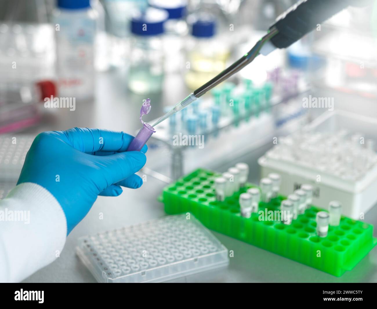 Hands of scientist pipetting chemical formula in vial at laboratory ...
