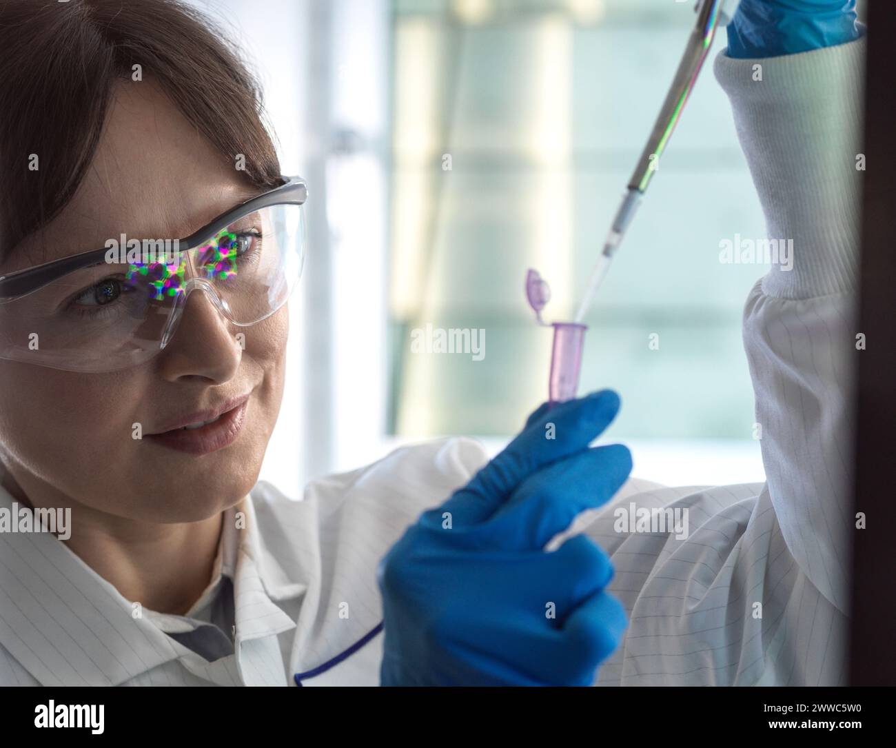 Scientist pipetting chemical sample for molecular research in laboratory Stock Photo - Alamy