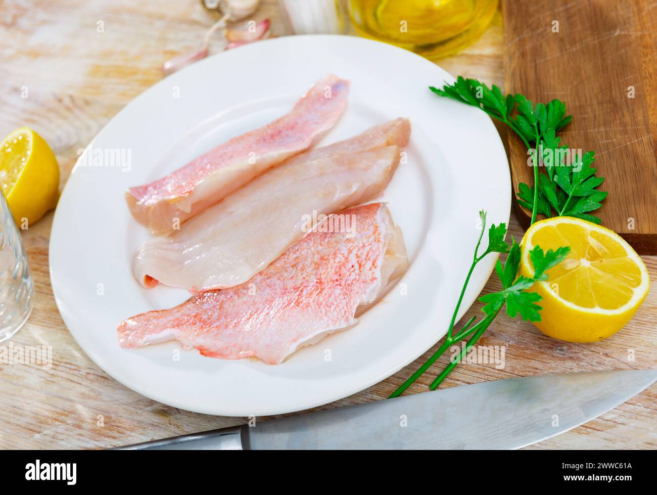 Raw rockfish fillet with condiments, cooking ingredients Stock Photo ...