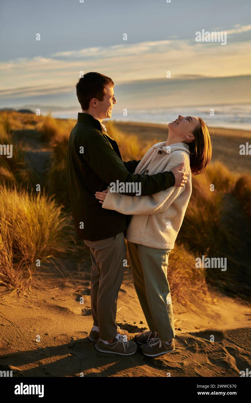 Girlfriend and boyfriend laughing and hugging at ocean beach Stock ...