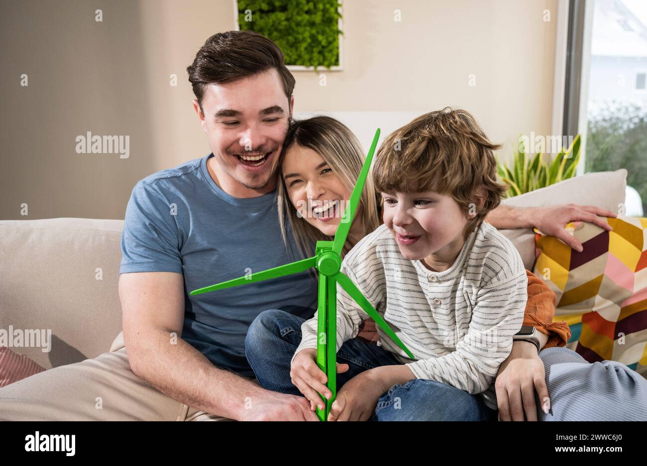 Happy family with wind turbine model at home Stock Photo - Alamy