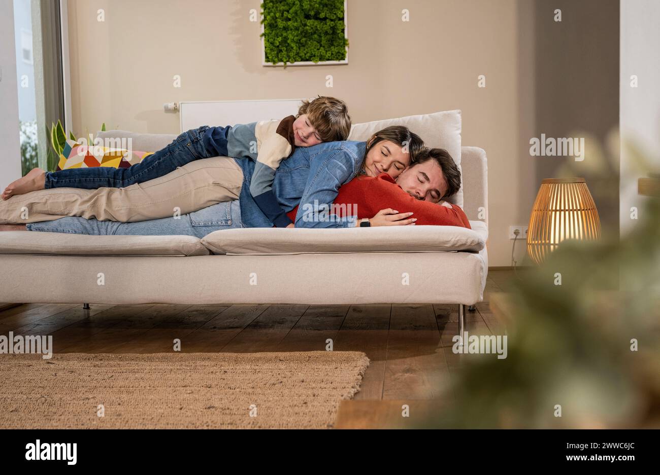 Happy family sleeping on sofa at home Stock Photo - Alamy