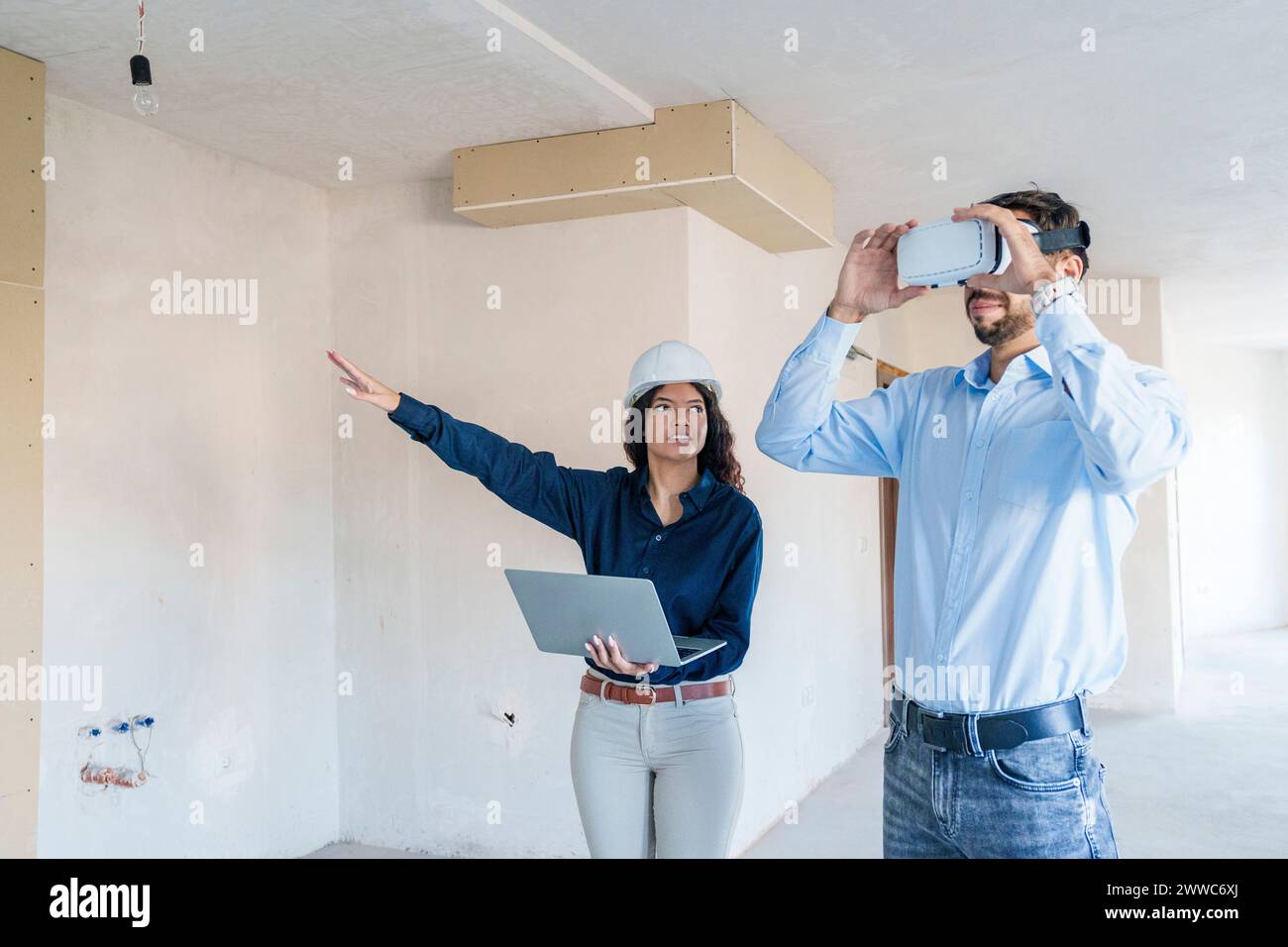 Real estate agent showing customer renovation ideas of new house ...