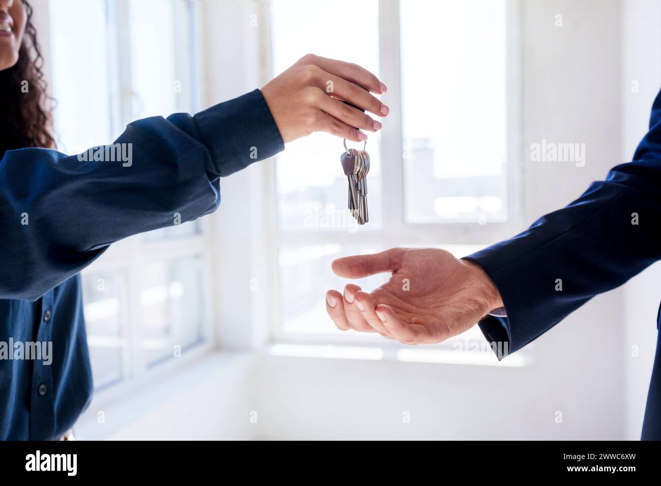 Real estate agent giving keys to new owner of house Stock Photo - Alamy
