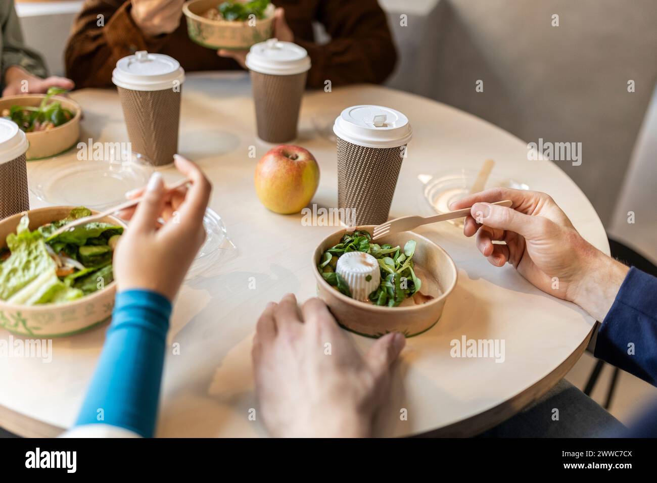 Business colleagues having salad in lunch at office cafe Stock Photo ...