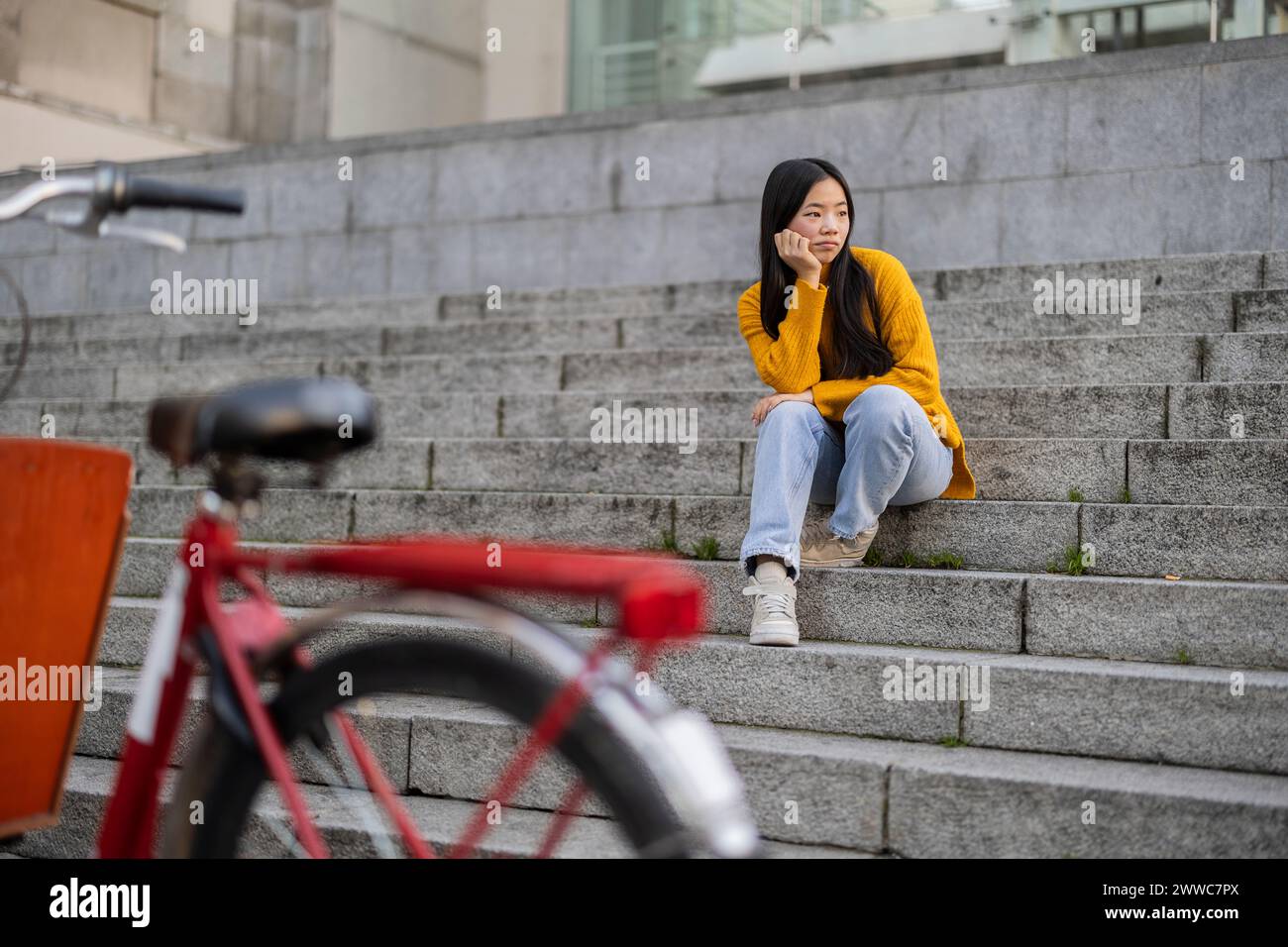 Sad young woman sits on hi-res stock photography and images - Alamy