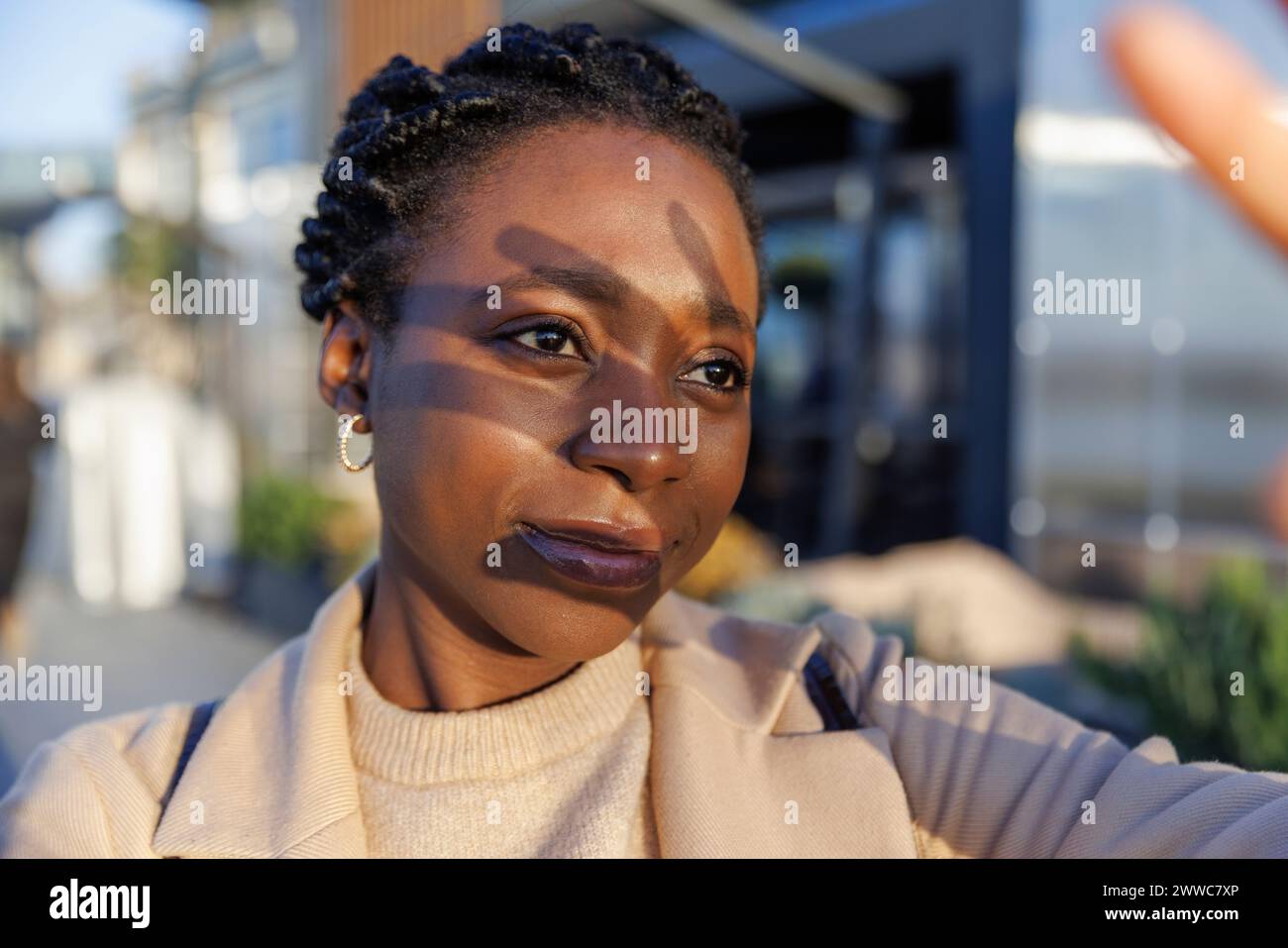 Woman shielding eyes from light hi-res stock photography and images - Alamy