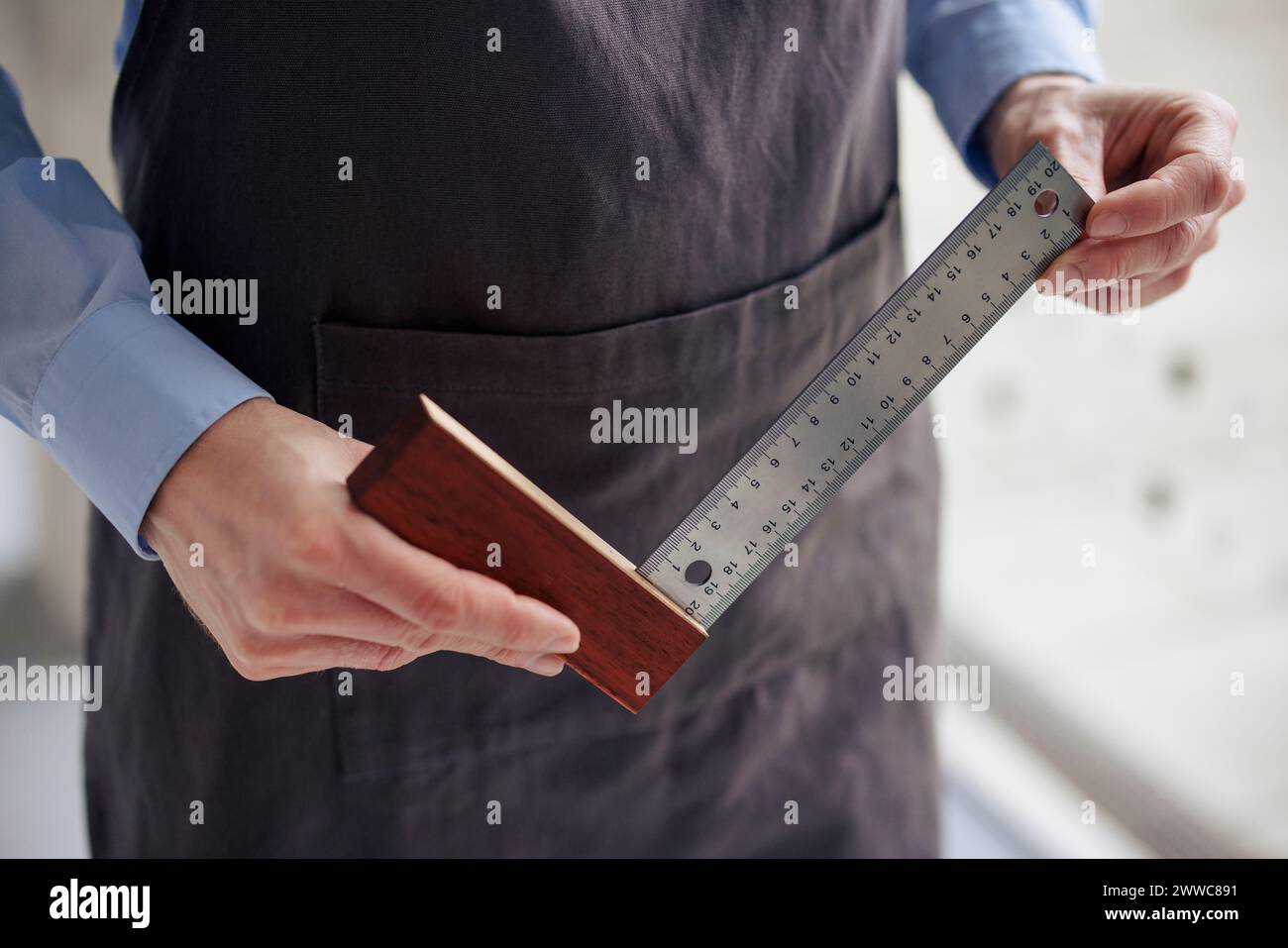 Engineer holding measuring ruler at workshop Stock Photo - Alamy
