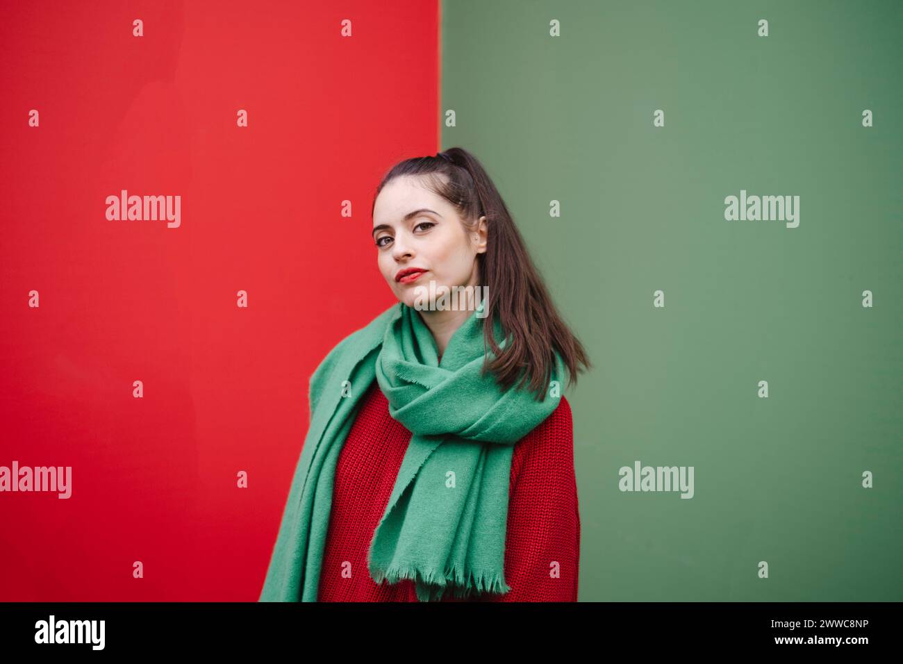 Woman wearing scarf and standing in front of wall Stock Photo - Alamy