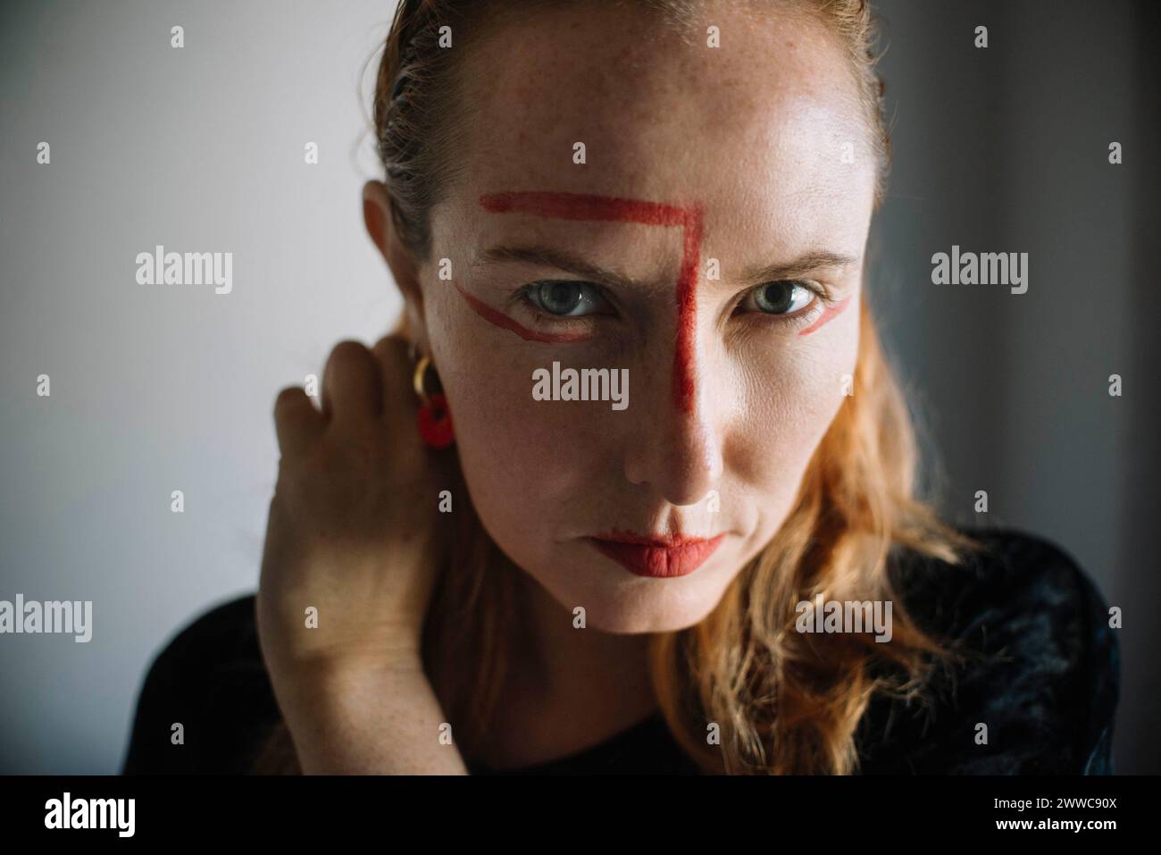 Serious woman staring against gray background Stock Photo - Alamy