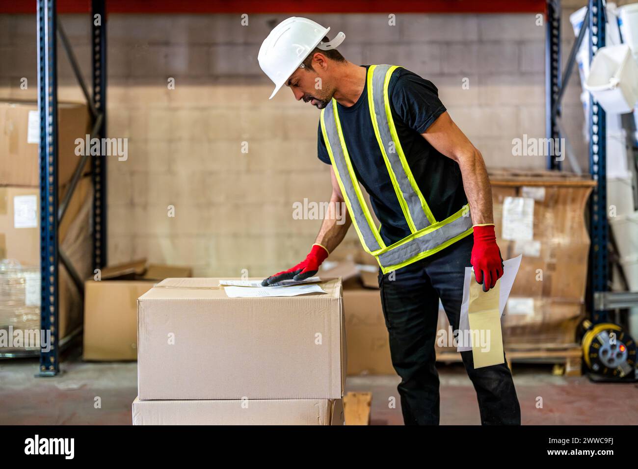 Worker examining checklist at warehouse Stock Photo - Alamy