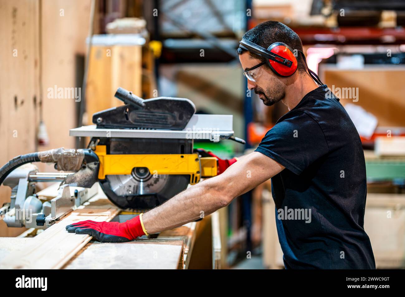 Carpenter cutting wood with electric saw Stock Photo - Alamy