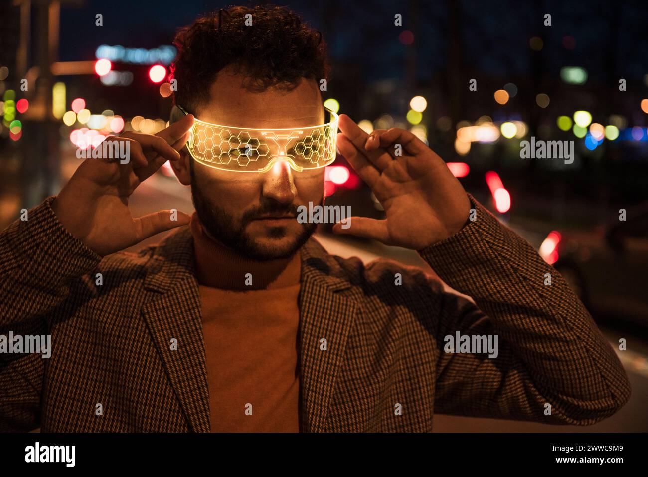 Man wearing smart glasses at night Stock Photo - Alamy