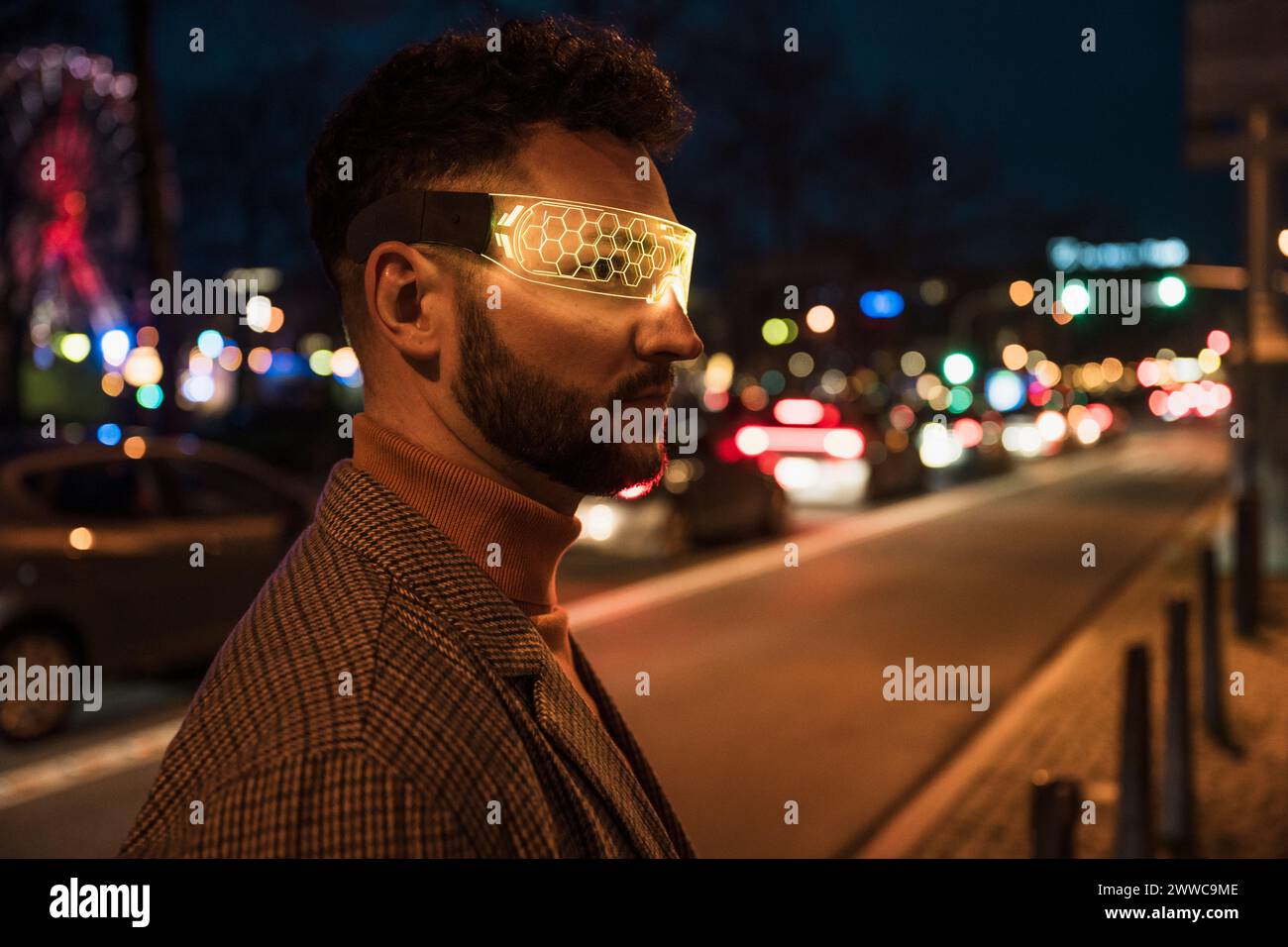 Man wearing smart glasses on street at night Stock Photo - Alamy