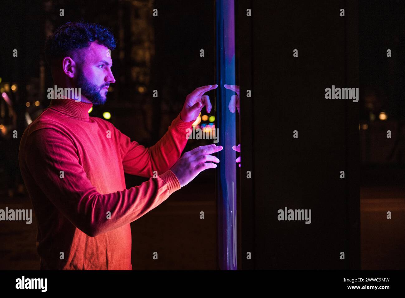 Man using touch screen kiosk at night Stock Photo - Alamy