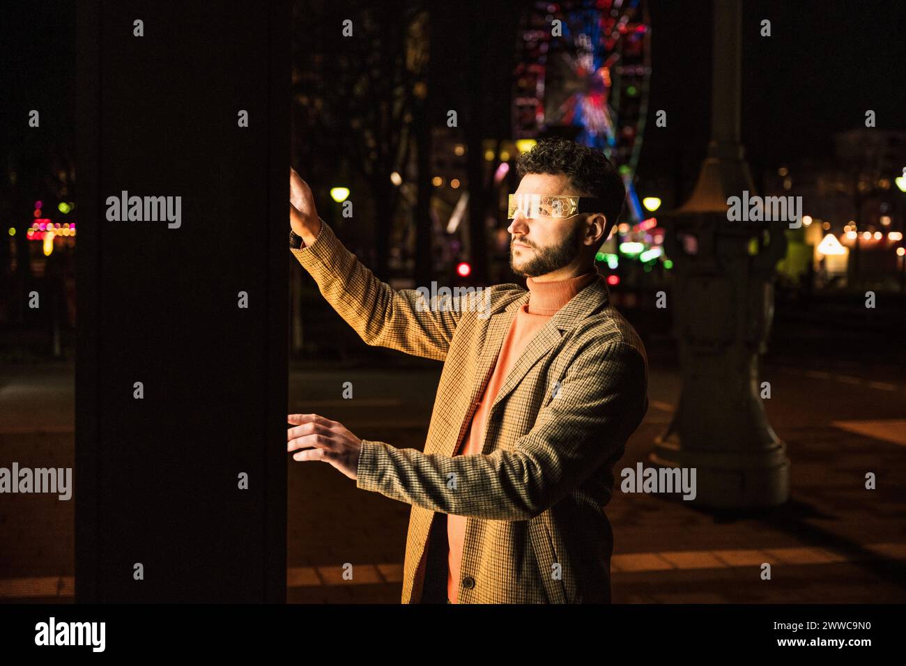 Man wearing smart glasses using touch screen kiosk on street Stock ...