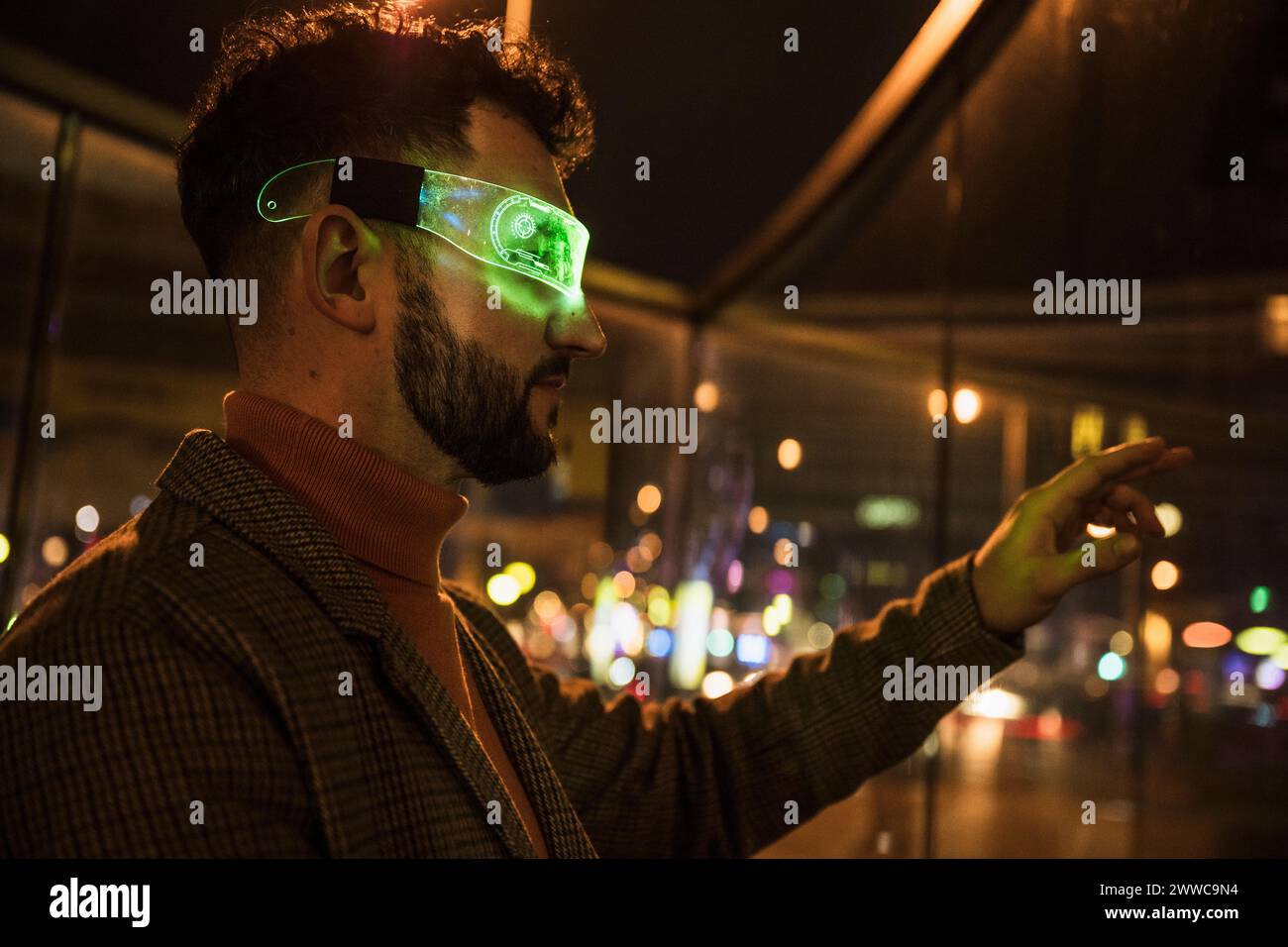 Man wearing smart glasses and gesturing near glass Stock Photo - Alamy