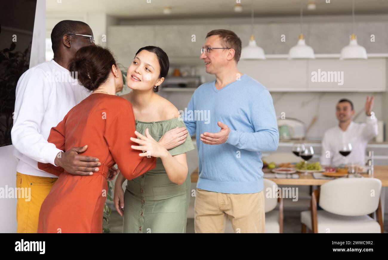 Happy group family friends greet hi-res stock photography and images ...
