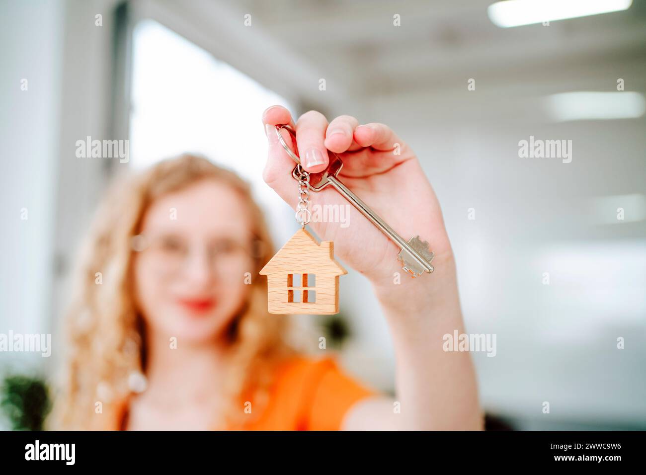 Woman holding key of new home Stock Photo - Alamy
