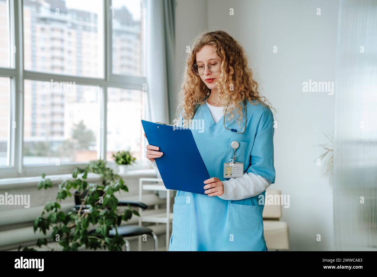 Doctor reading medical document at hospital Stock Photo - Alamy