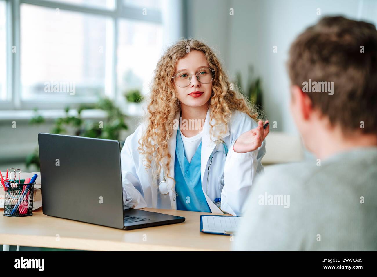Doctor giving patient documents hi-res stock photography and images - Alamy