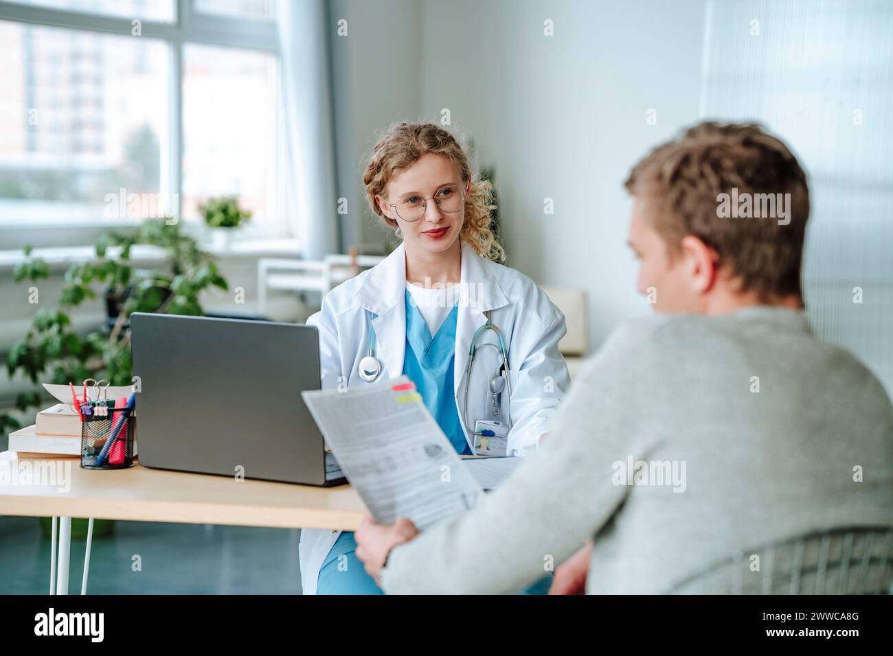 Doctor giving patient documents hi-res stock photography and images - Alamy