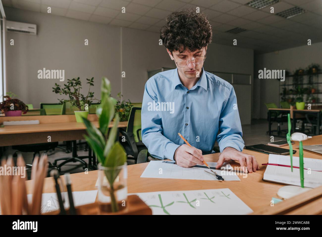 Engineer drawing diagram on paper in office Stock Photo - Alamy