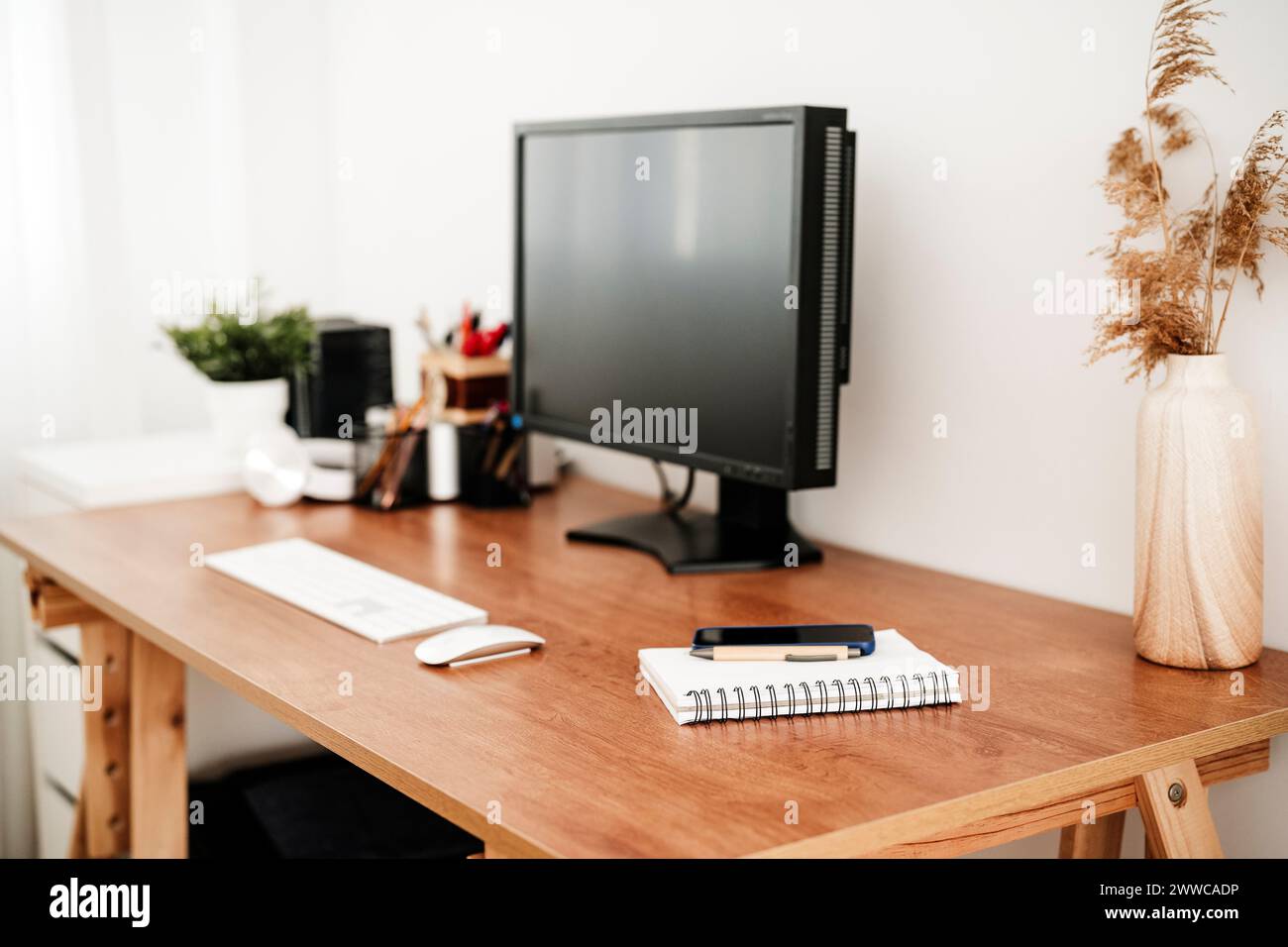 Computer on desk in home office Stock Photo - Alamy