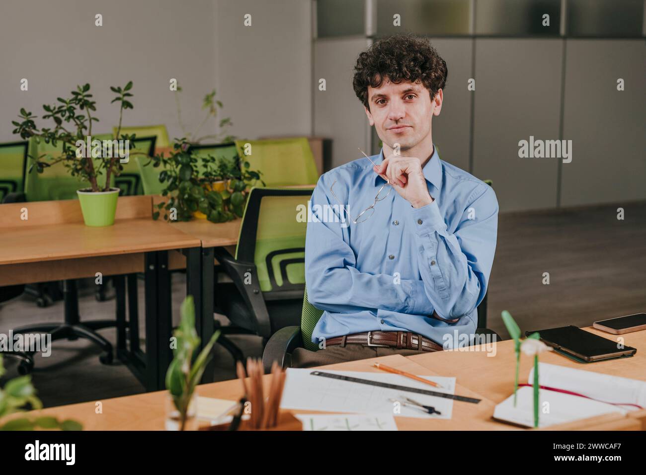 Engineer sitting on chair in office Stock Photo - Alamy