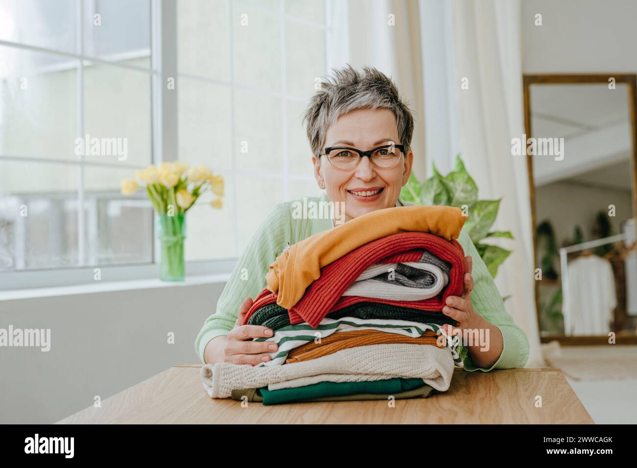 Woman sorting clothes home hi-res stock photography and images - Alamy