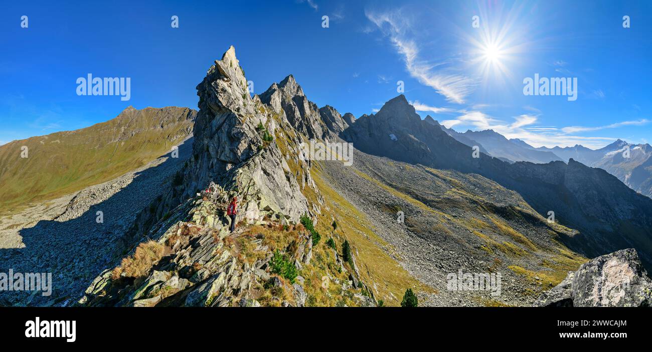 Austria, Tyrol, Sun shining over female hiker following Aschaffenburger ...