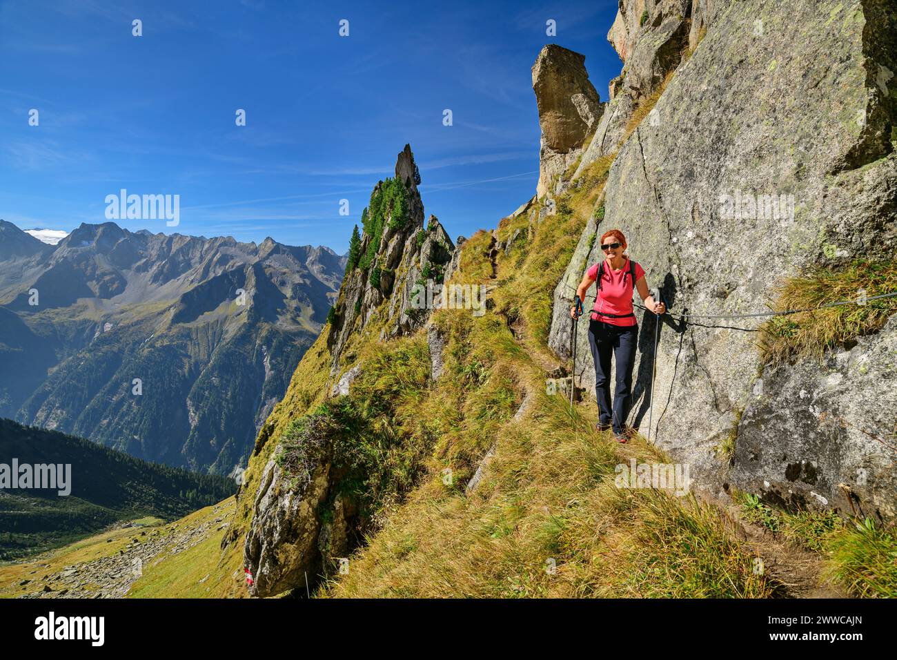 Austria, Tyrol, Female hiker following Aschaffenburger Hohenweg trail ...