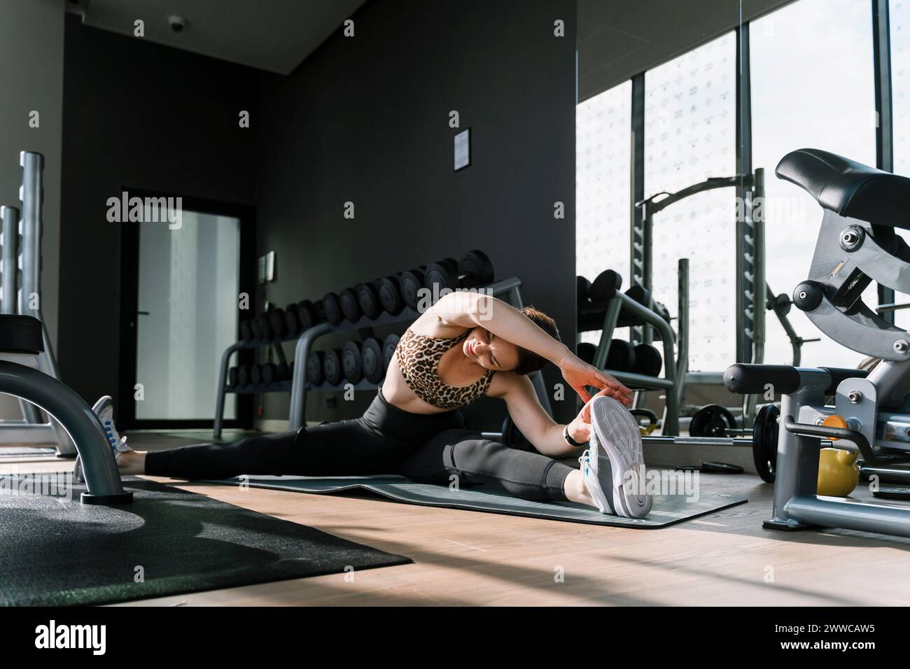 Woman doing stretches hi-res stock photography and images - Alamy