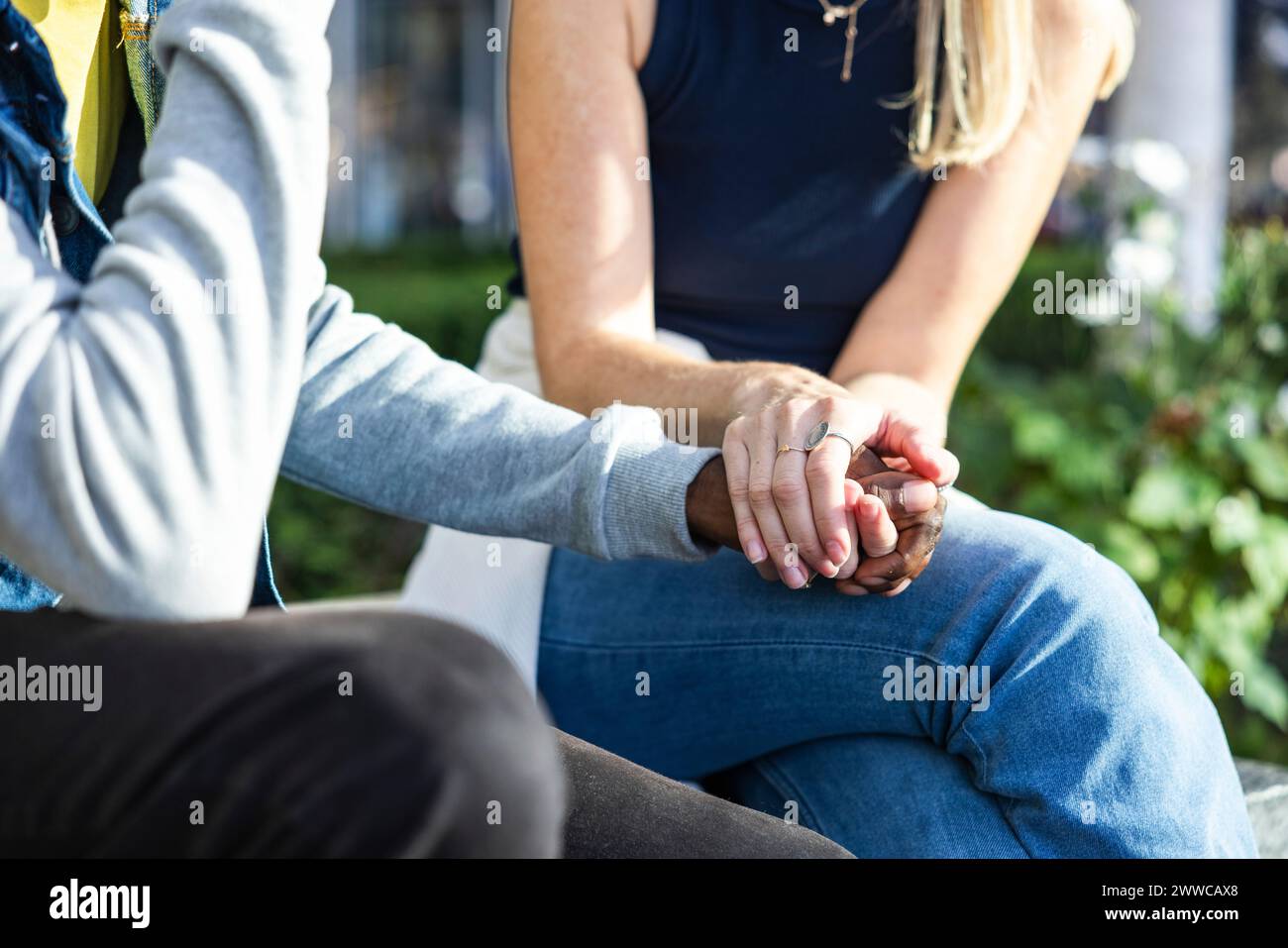 Young woman consoling friend in city Stock Photo - Alamy