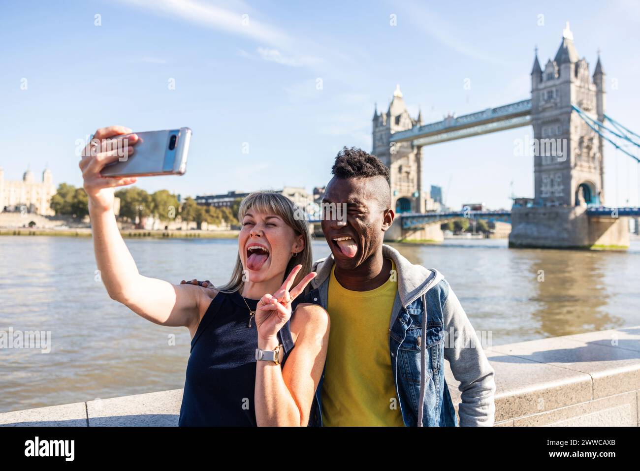 Multiracial tourists friends sticking out tongue and talking selfie on ...