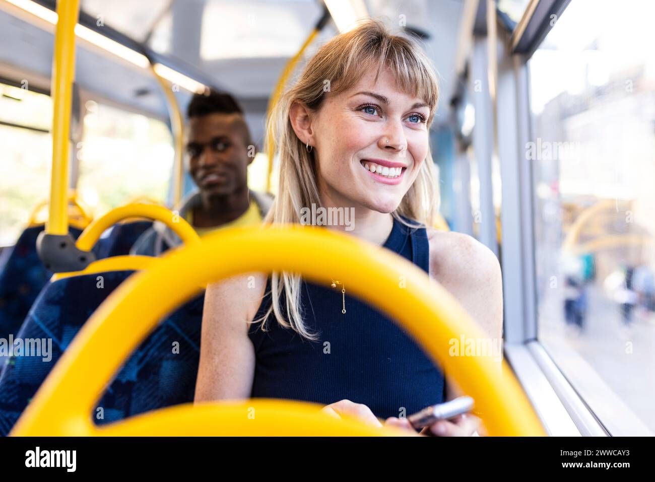 Excited young woman traveling in double-decker bus Stock Photo - Alamy