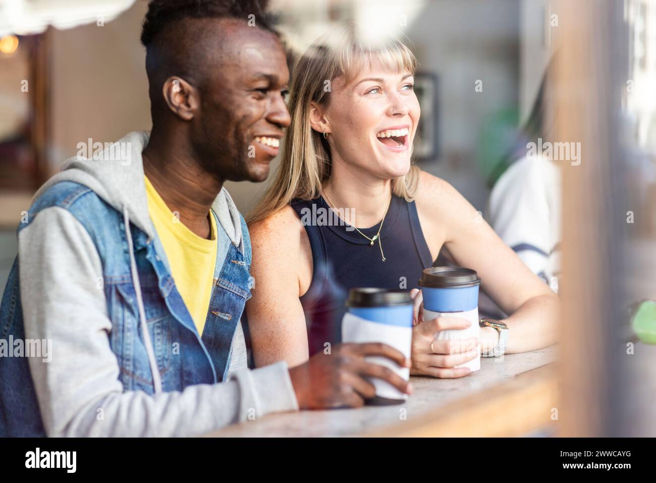 Happy customers looking through glass hi-res stock photography and ...